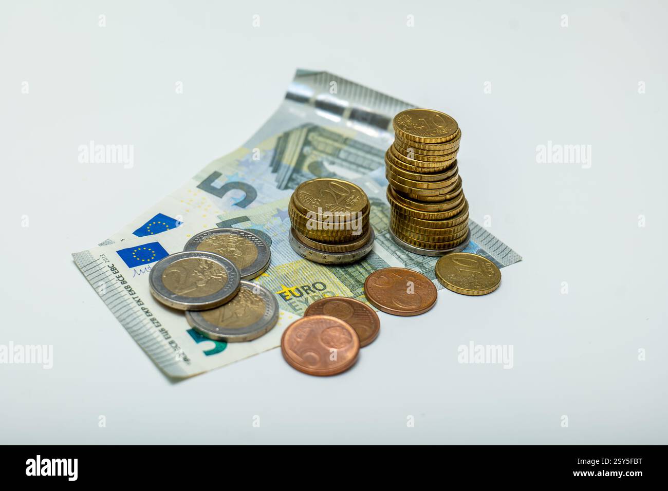 5 euro banknotes and coins isolated on white background Stock Photo - Alamy