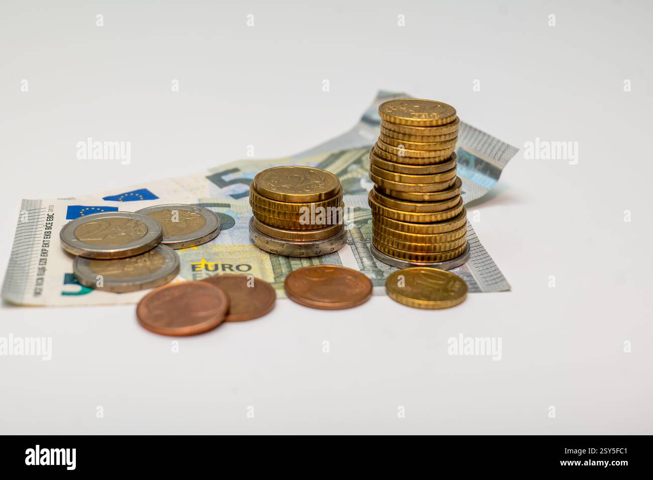 5 euro banknotes and coins isolated on white background Stock Photo - Alamy