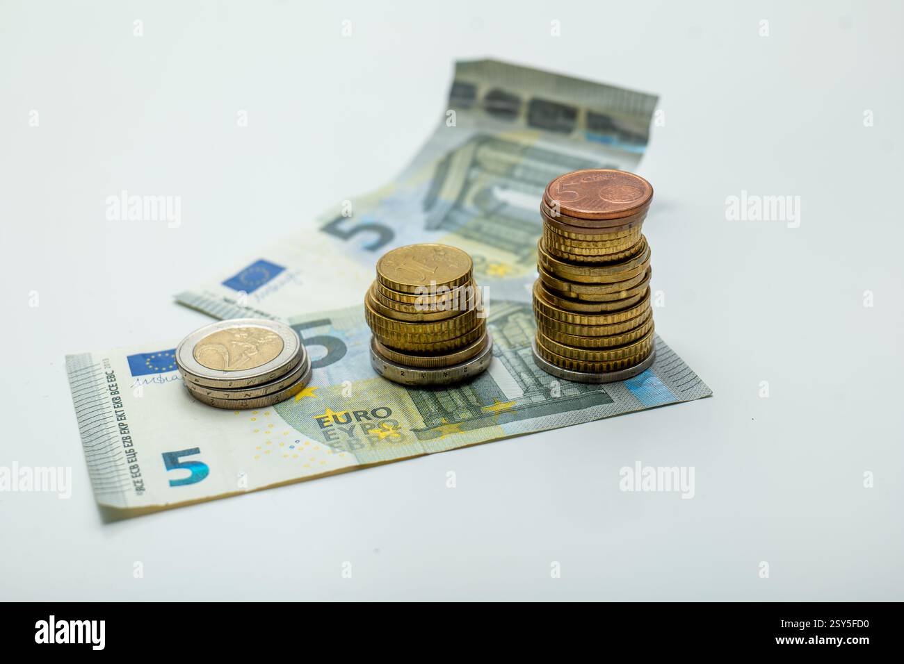5 euro banknotes and coins isolated on white background Stock Photo - Alamy