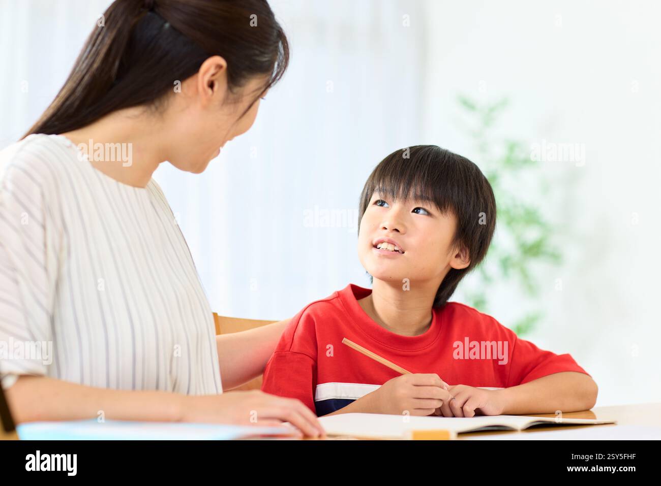 Japanese Mother And Son Doing Homework At Home Stock Photo - Alamy