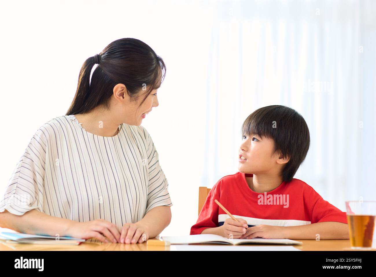 Japanese Mother And Son Doing Homework At Home Stock Photo - Alamy
