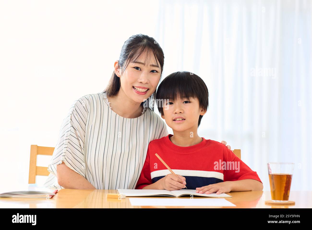 Japanese Mother And Son Doing Homework At Home Stock Photo - Alamy