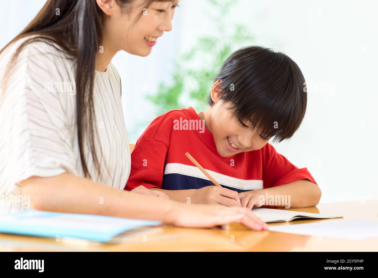 Japanese Mother And Son Doing Homework At Home Stock Photo - Alamy
