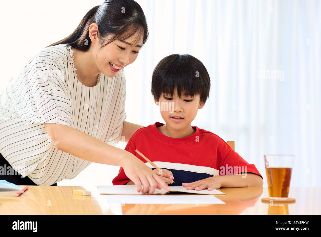 Japanese Mother And Son Doing Homework At Home Stock Photo - Alamy