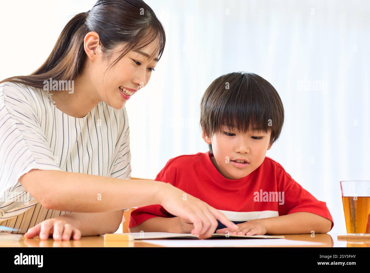 Japanese Mother And Son Doing Homework At Home Stock Photo - Alamy