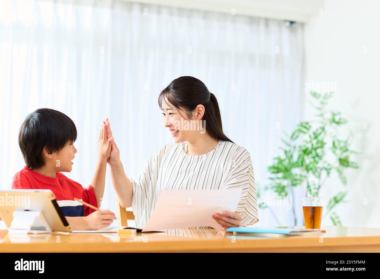 Japanese Mother And Son Doing Homework At Home Stock Photo - Alamy