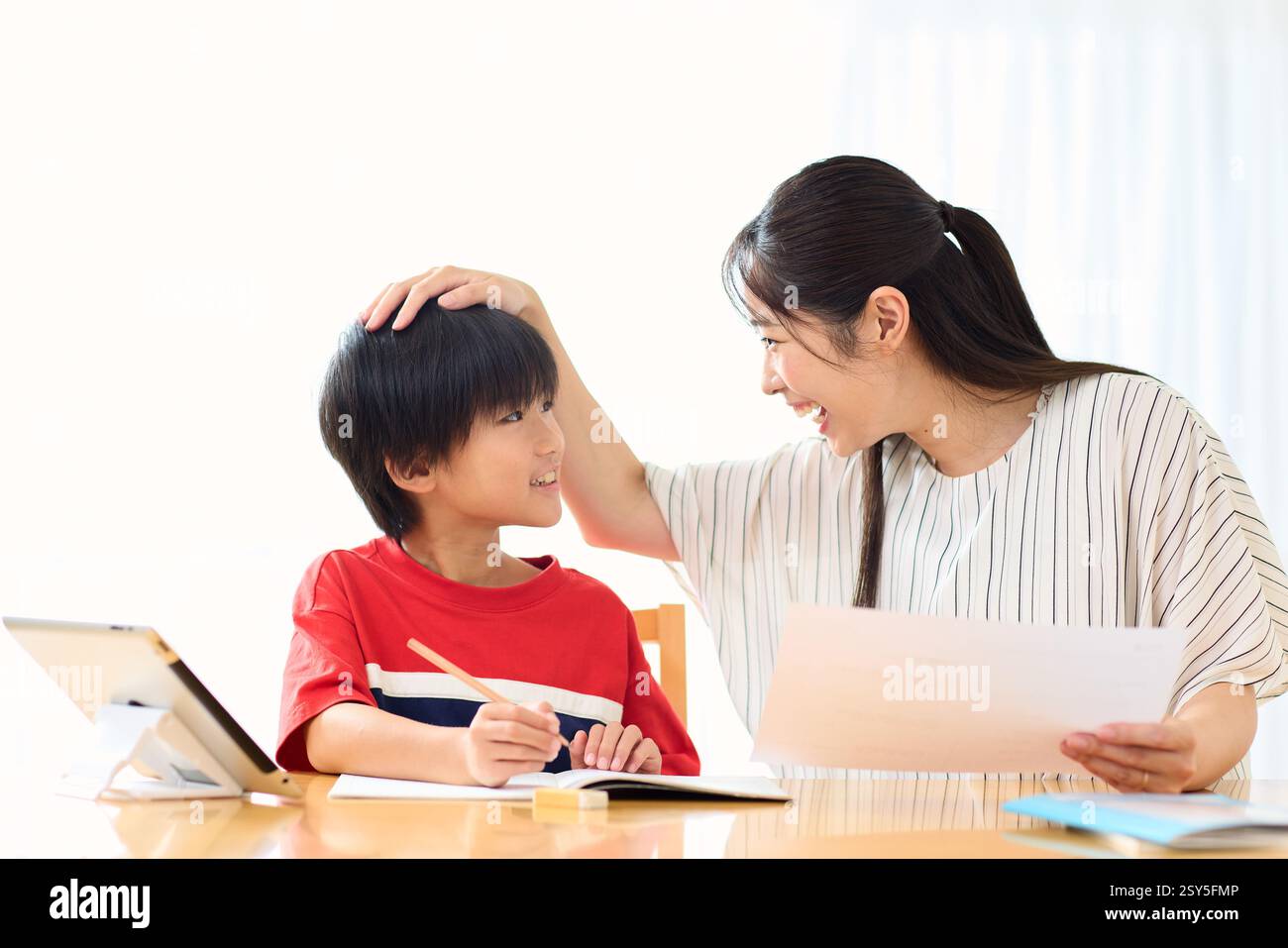 Japanese Mother And Son Doing Homework At Home Stock Photo - Alamy