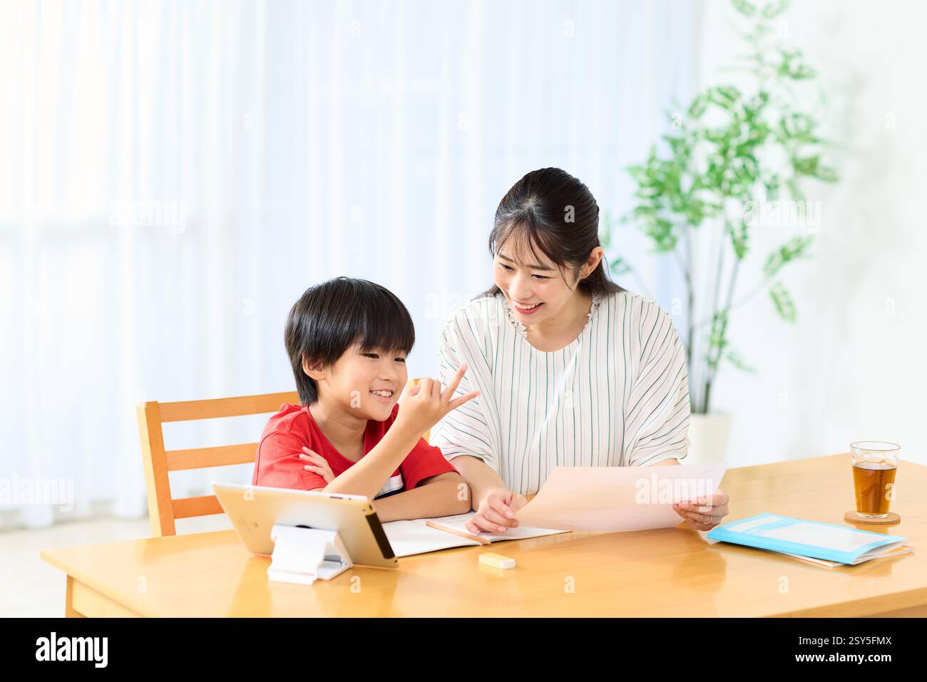 Japanese Mother And Son Doing Homework At Home Stock Photo - Alamy