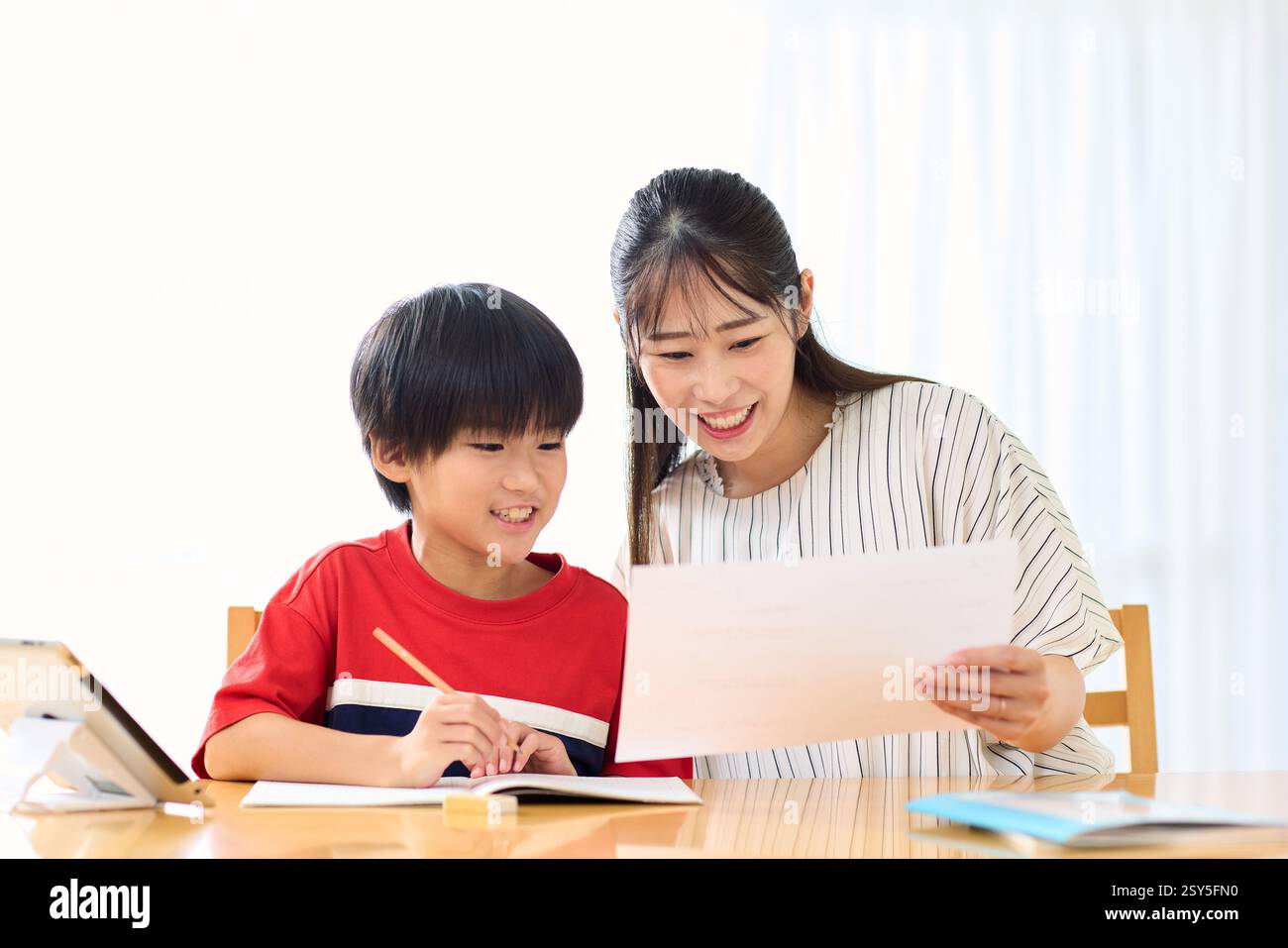 Japanese Mother And Son Doing Homework At Home Stock Photo - Alamy