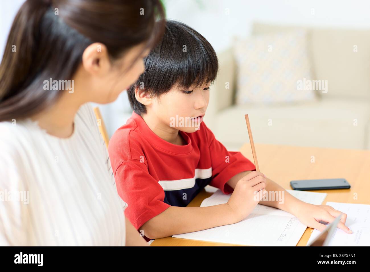 Japanese Mother And Son Doing Homework At Home Stock Photo - Alamy
