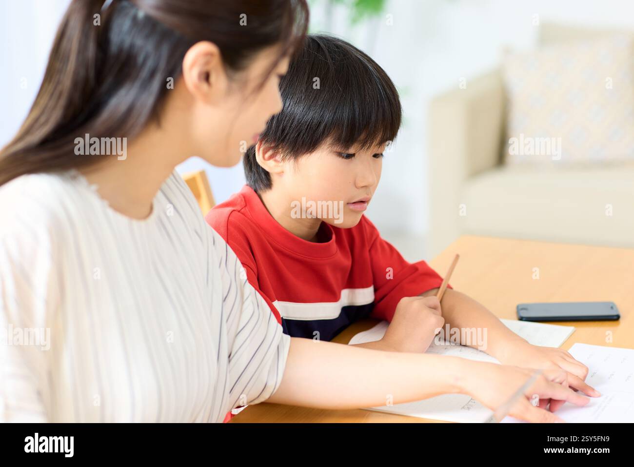 Japanese Mother And Son Doing Homework At Home Stock Photo - Alamy