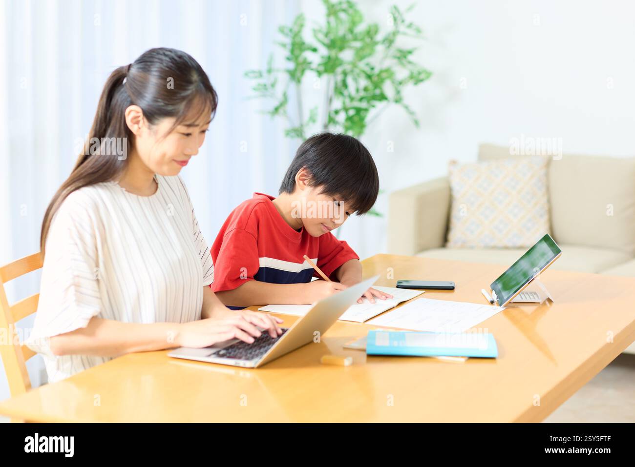 Japanese Mother And Son Doing Homework At Home Stock Photo - Alamy