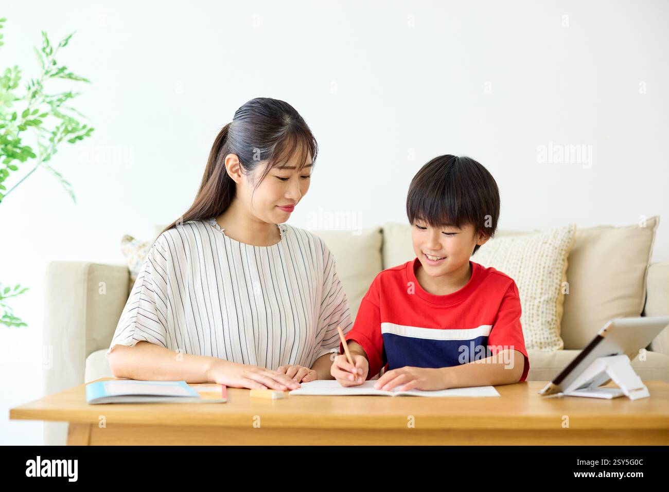 Japanese Mother And Son Doing Homework At Home Stock Photo - Alamy
