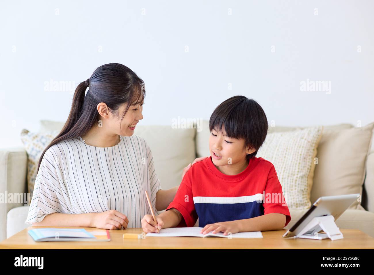 Japanese Mother And Son Doing Homework At Home Stock Photo - Alamy