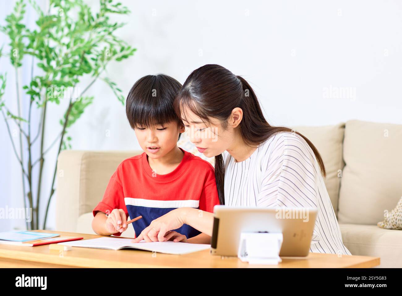 Japanese Mother And Son Doing Homework At Home Stock Photo - Alamy