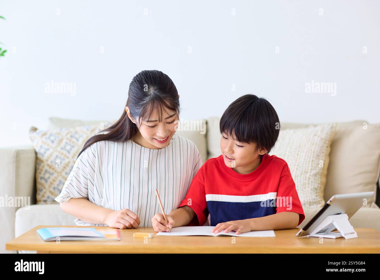 Japanese Mother And Son Doing Homework At Home Stock Photo - Alamy