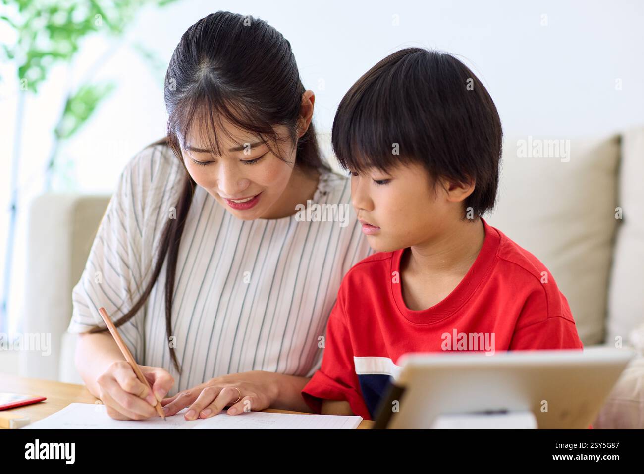 Japanese Mother And Son Doing Homework At Home Stock Photo - Alamy