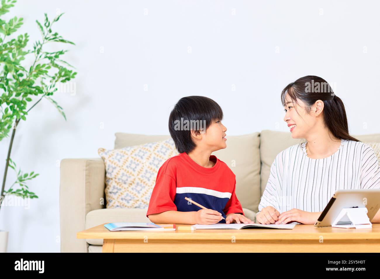 Japanese Mother And Son Doing Homework At Home Stock Photo - Alamy