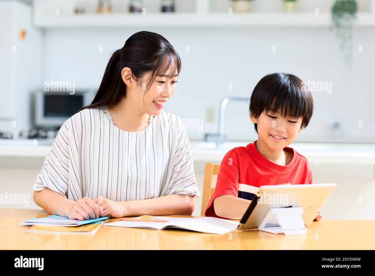 Japanese Mother And Son Doing Homework At Home Stock Photo - Alamy