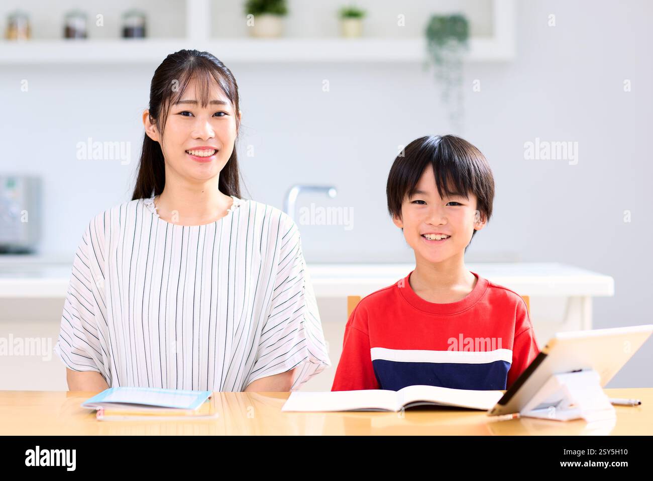 Japanese Mother And Son Doing Homework At Home Stock Photo - Alamy