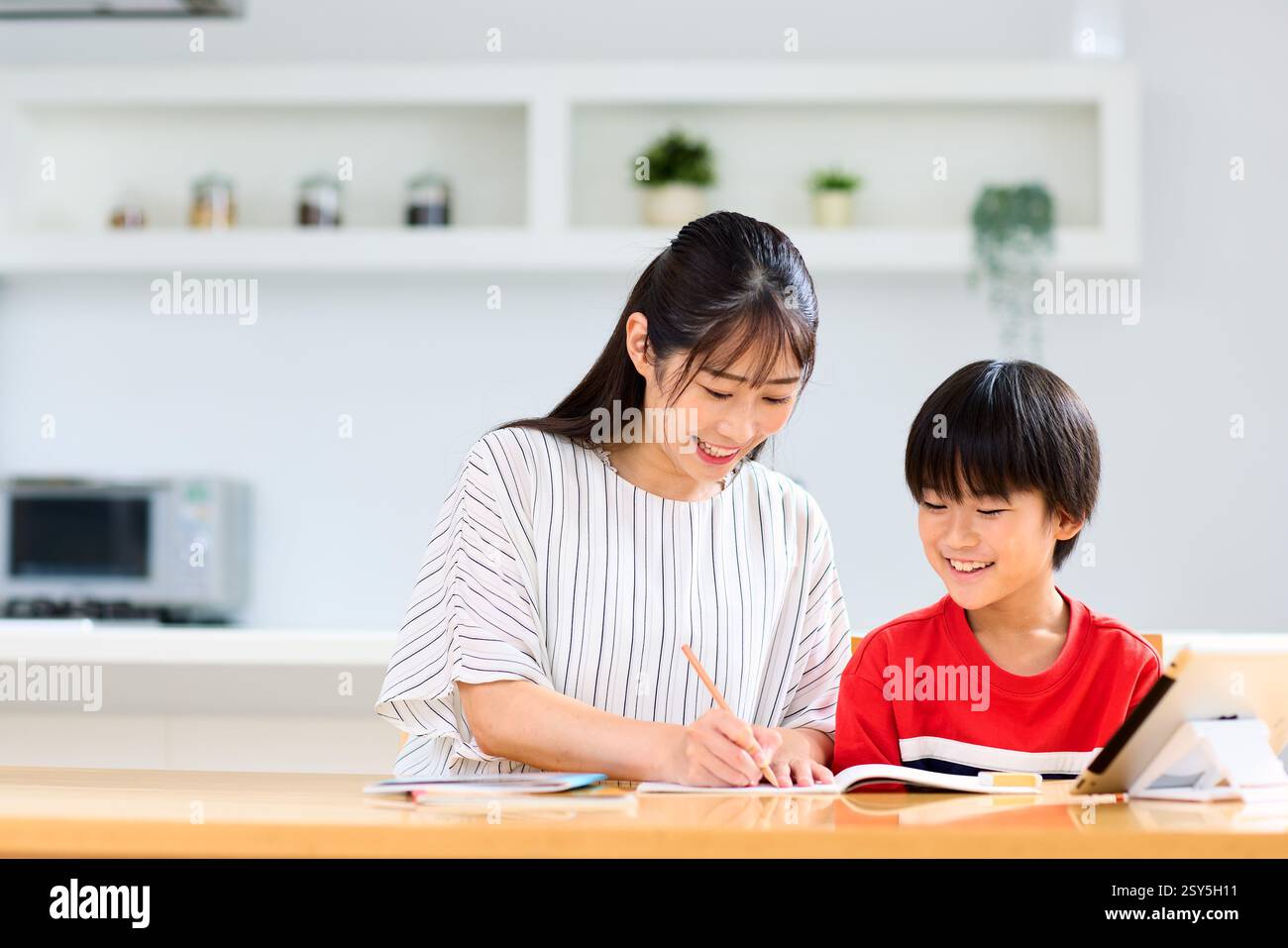 Japanese Mother And Son Doing Homework At Home Stock Photo - Alamy
