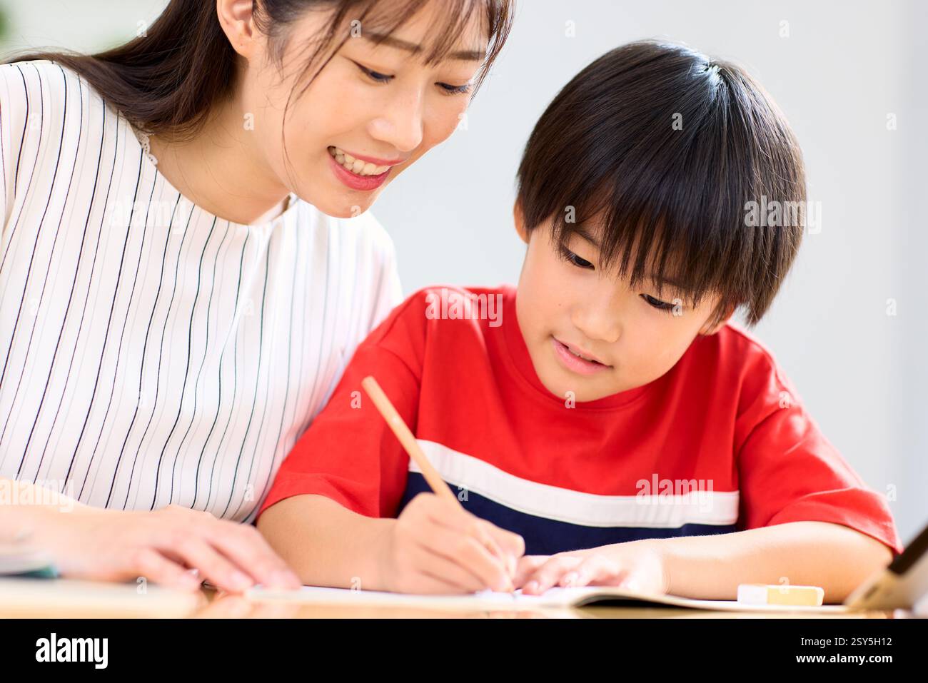 Japanese Mother And Son Doing Homework At Home Stock Photo - Alamy