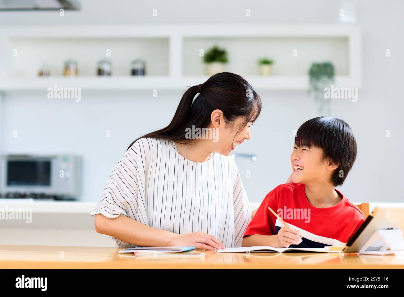 Japanese Mother And Son Doing Homework At Home Stock Photo - Alamy