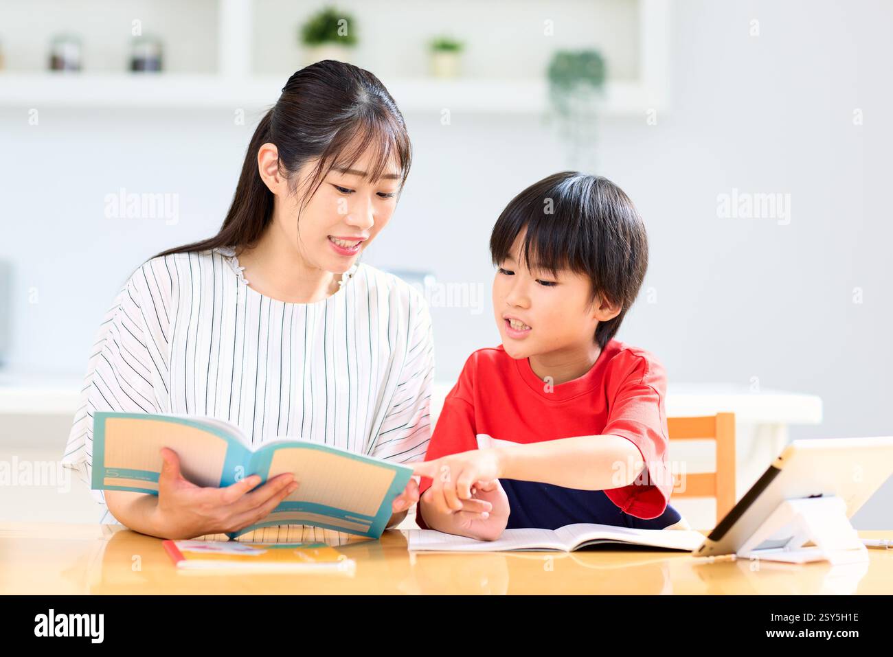 Japanese Mother And Son Doing Homework At Home Stock Photo - Alamy
