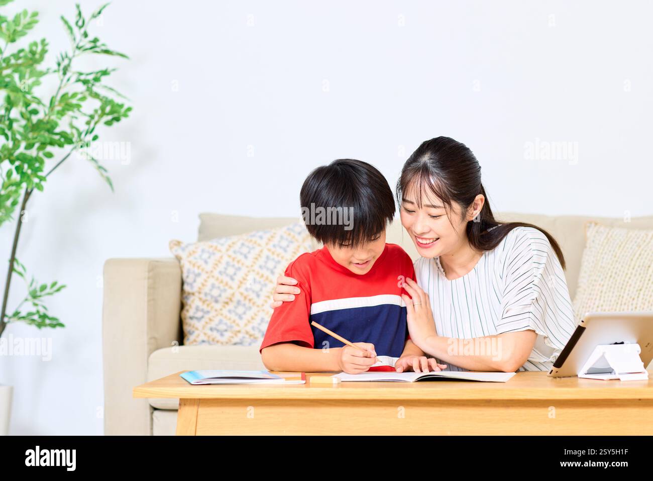Japanese Mother And Son Doing Homework At Home Stock Photo - Alamy