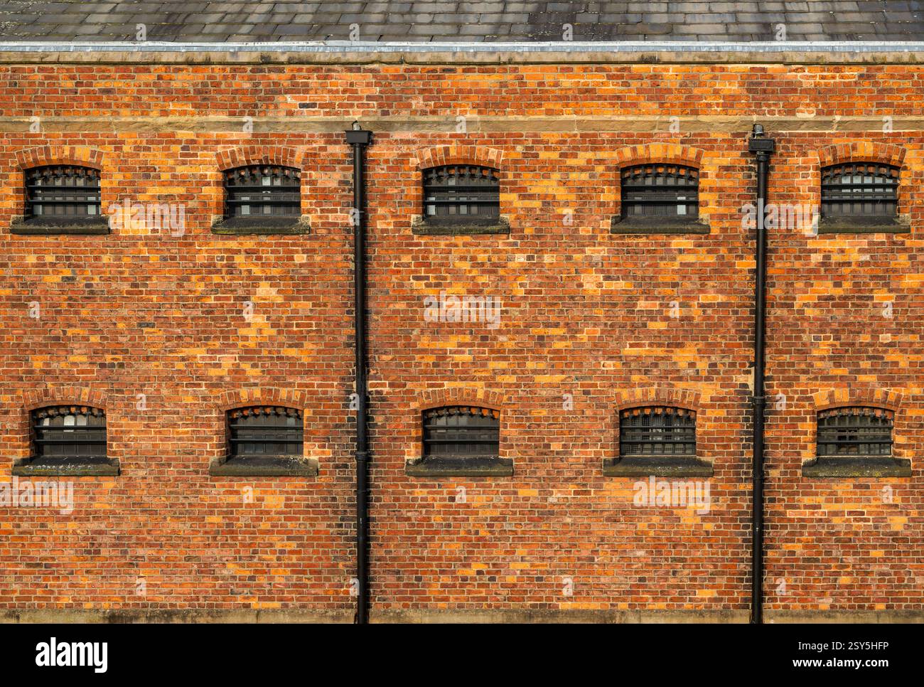 Cell windows with bars, exterior of Victorian jail museum, Lincoln ...