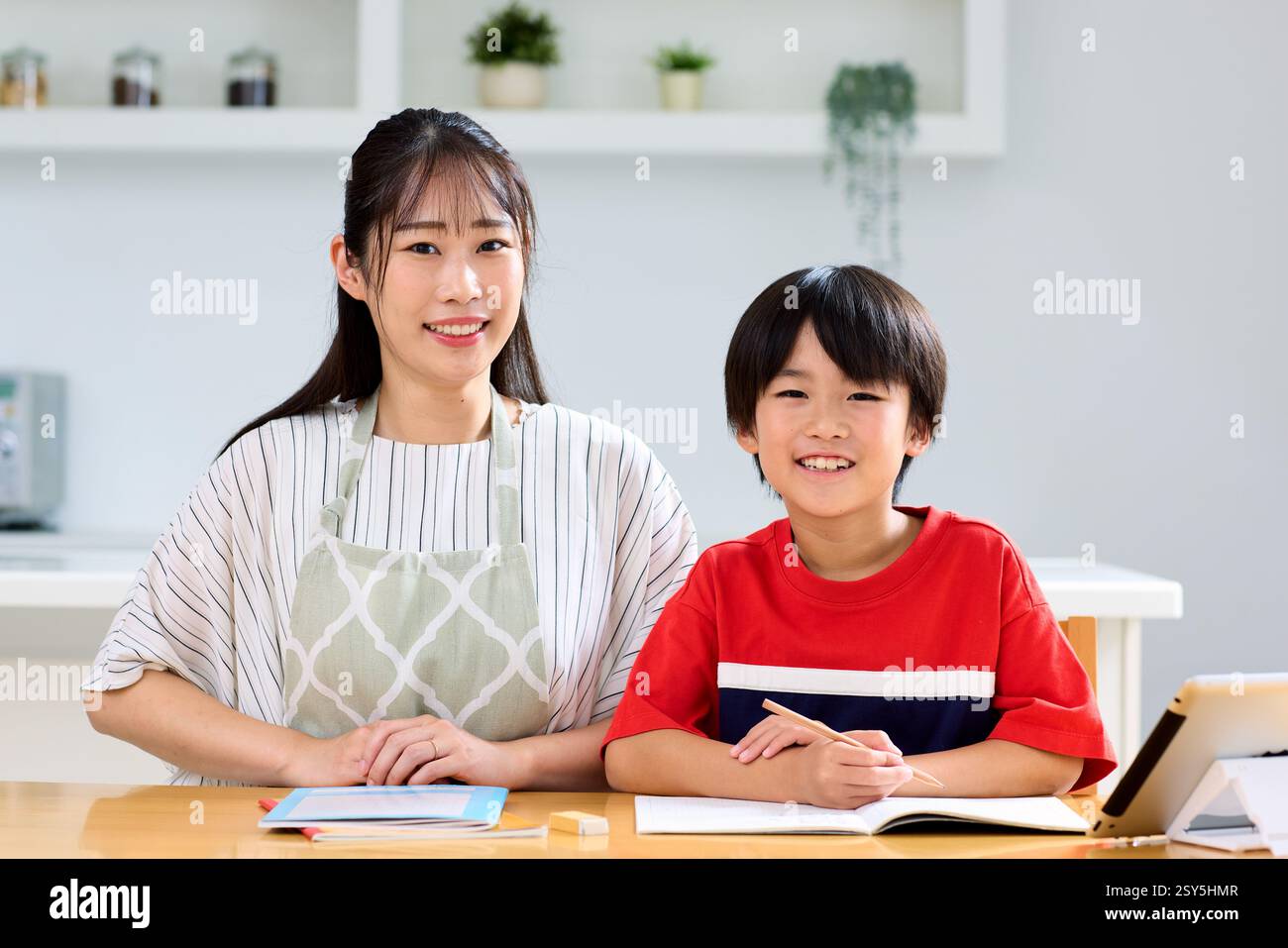 Japanese Mother And Son Working On Homework Stock Photo - Alamy