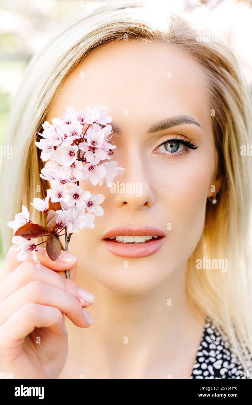 Portrait of attractive young woman with perfect skin holding cherry ...