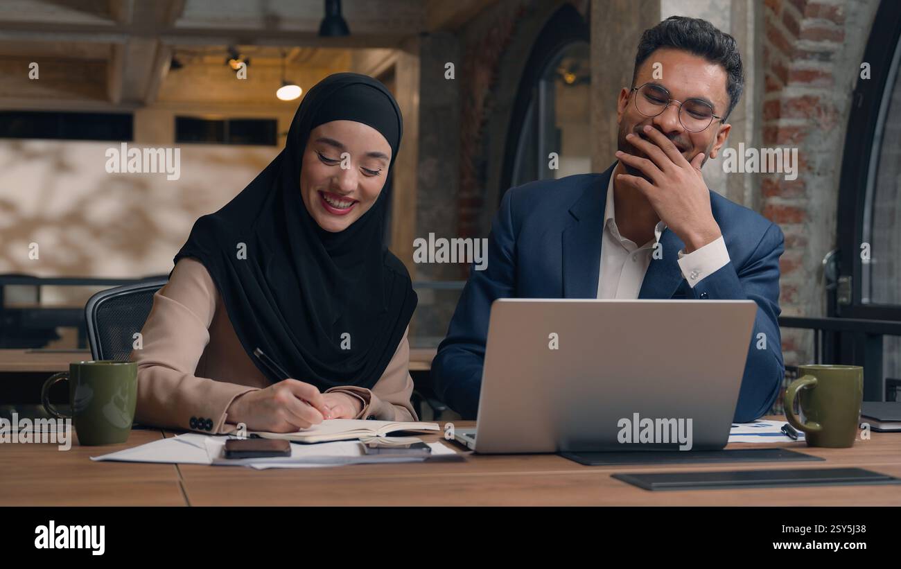 Two business colleagues co-workers talk discuss corporate work at ...