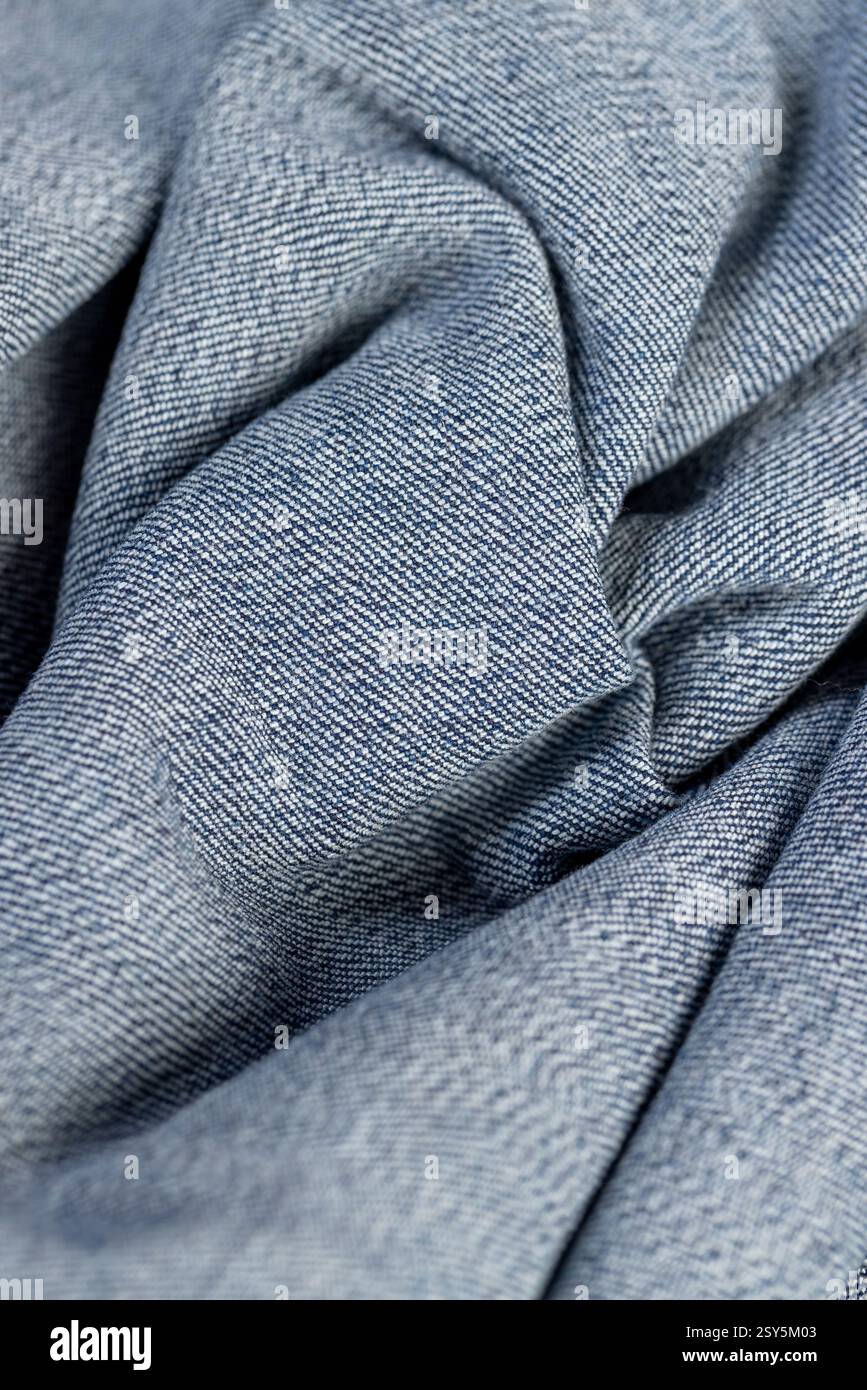 a piece of denim fabric for the production of clothing closeup ...