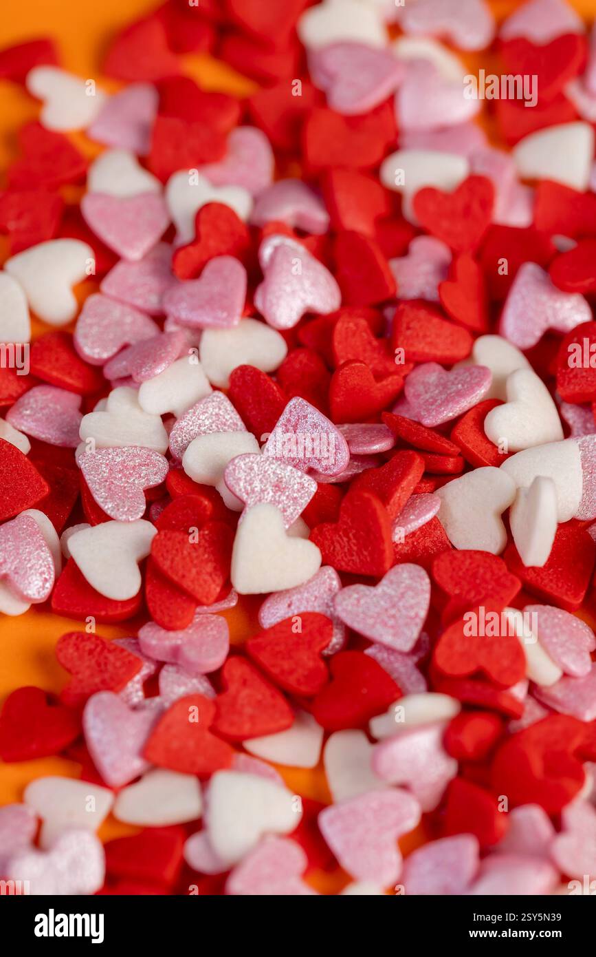 small candies in the shape of hearts, red white and pink sugar candies ...