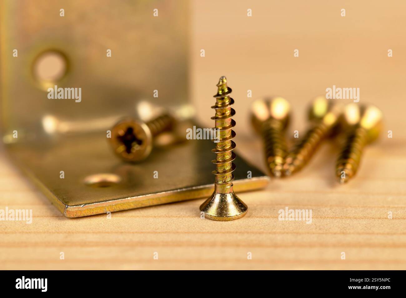 yellow corner and metal screws for construction work, a set of metal ...