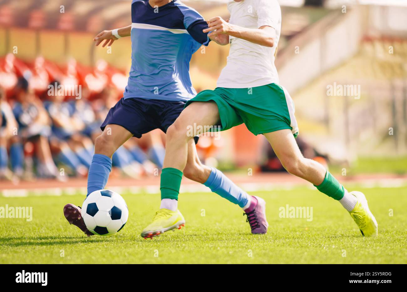 Soccer player kicking a ball on the field. Football duel between two ...