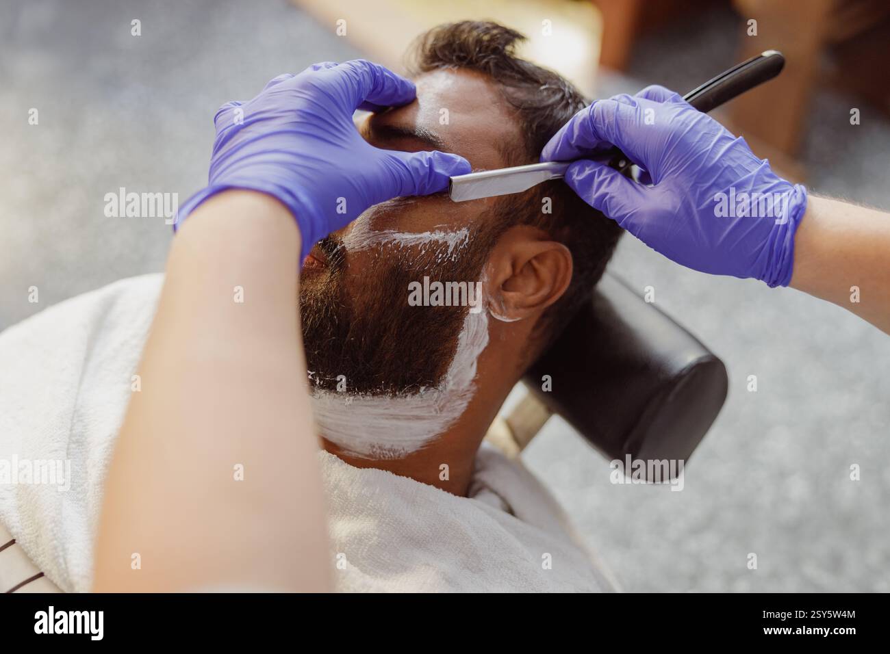 A Gentleman Enjoying a Classic Shave Experience at the Local Barber ...