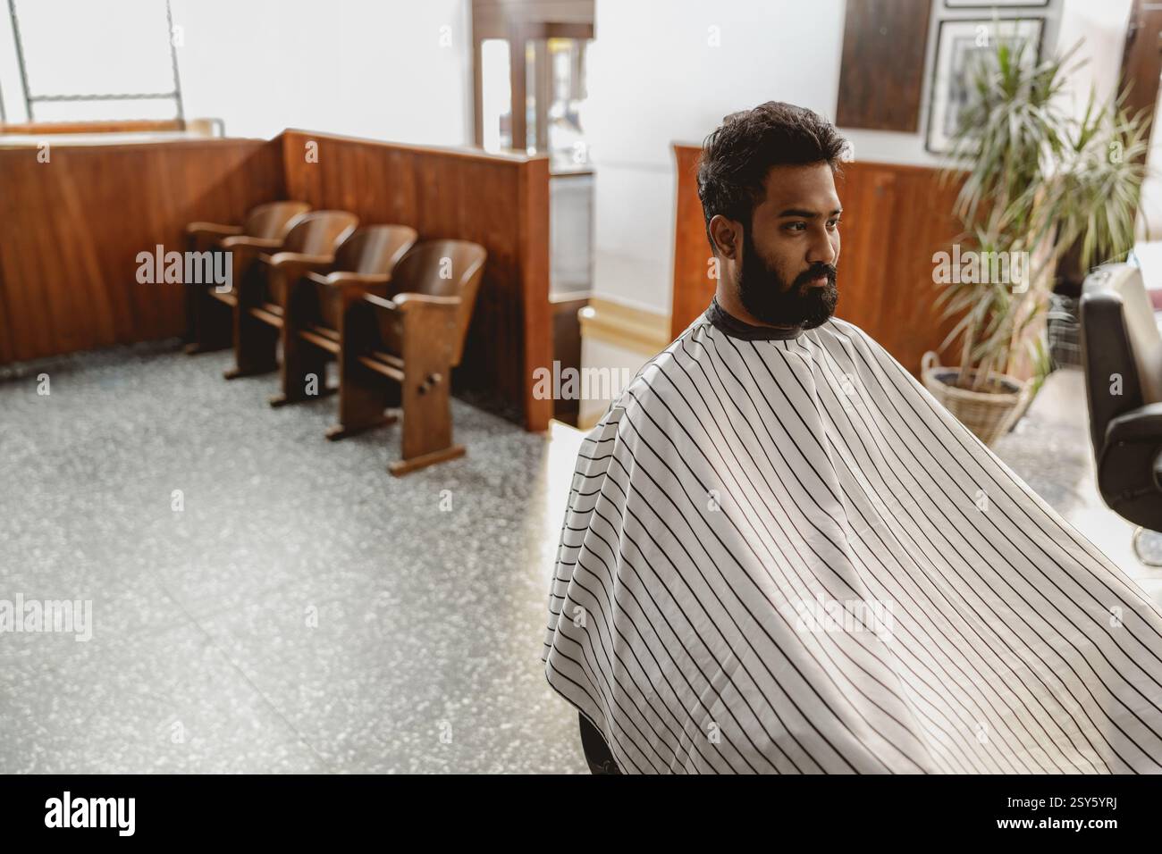 A Man is Getting a Haircut in a Classic Barbershop Setting That Exudes ...
