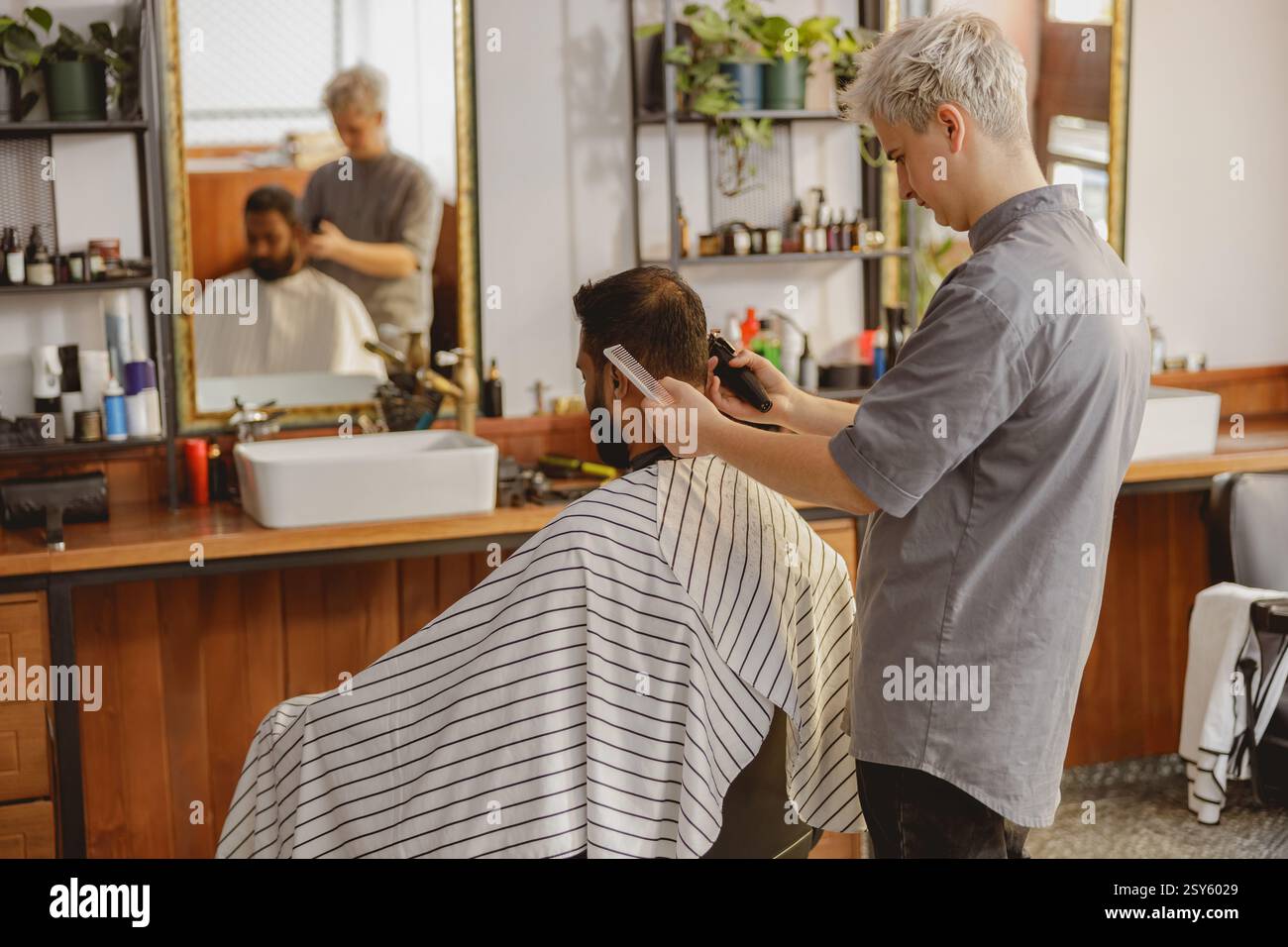 A Stylish Barber Skillfully Cutting Hair with Precision in a Modern ...
