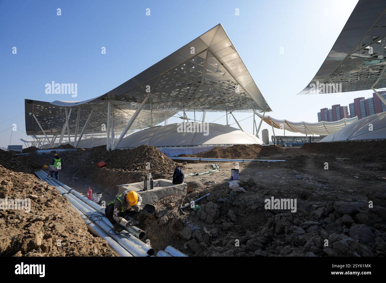 Beijing, China. 26th Feb, 2025. Workers are pictured at the ...