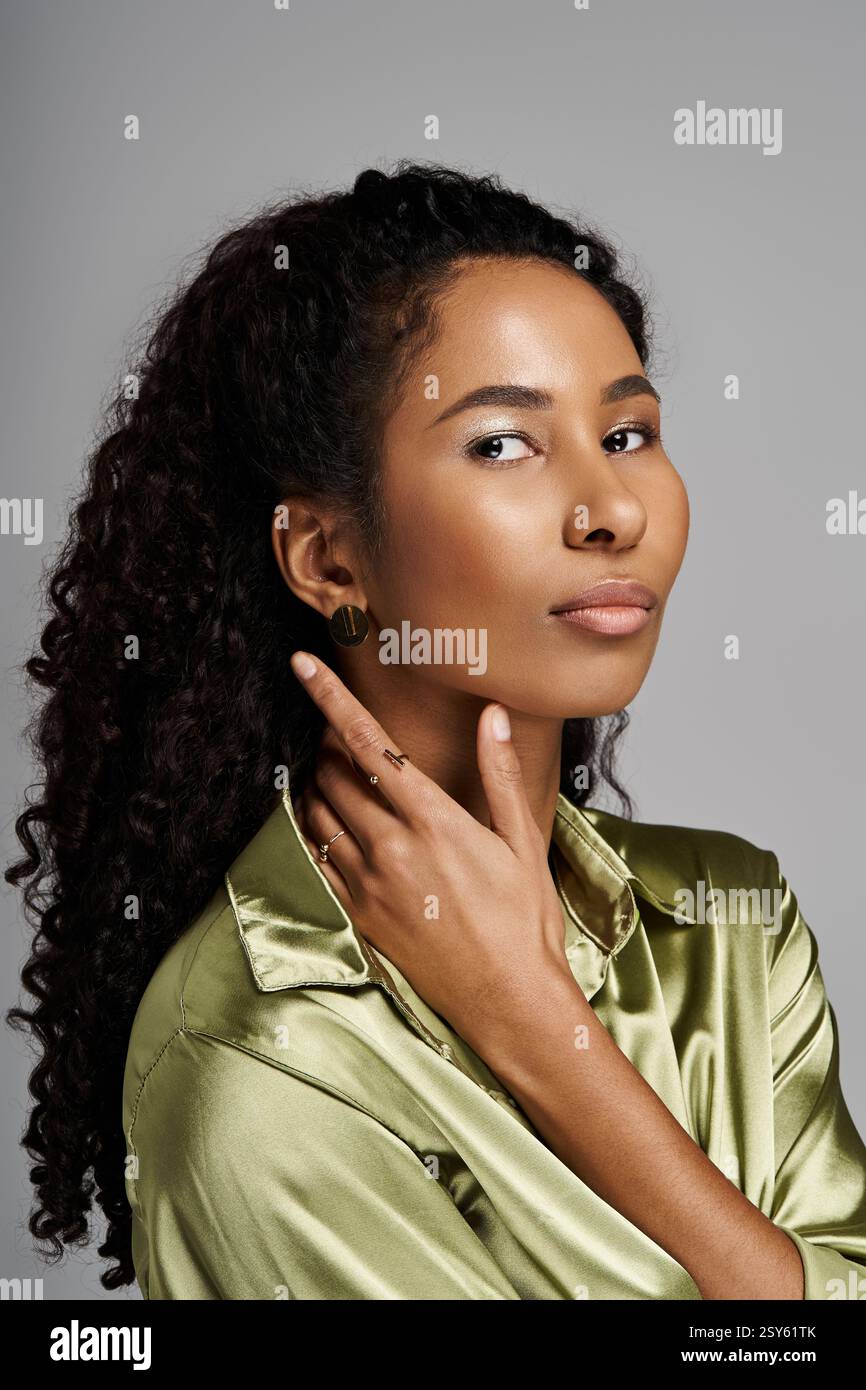 A stunning African American woman poses elegantly in stylish attire and ...