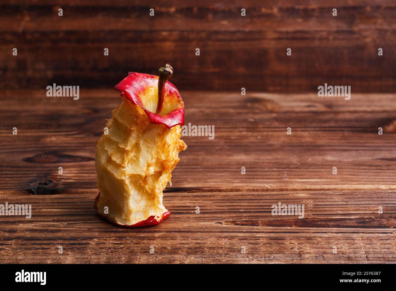 Rotten apple core on rustic wood Stock Photo - Alamy