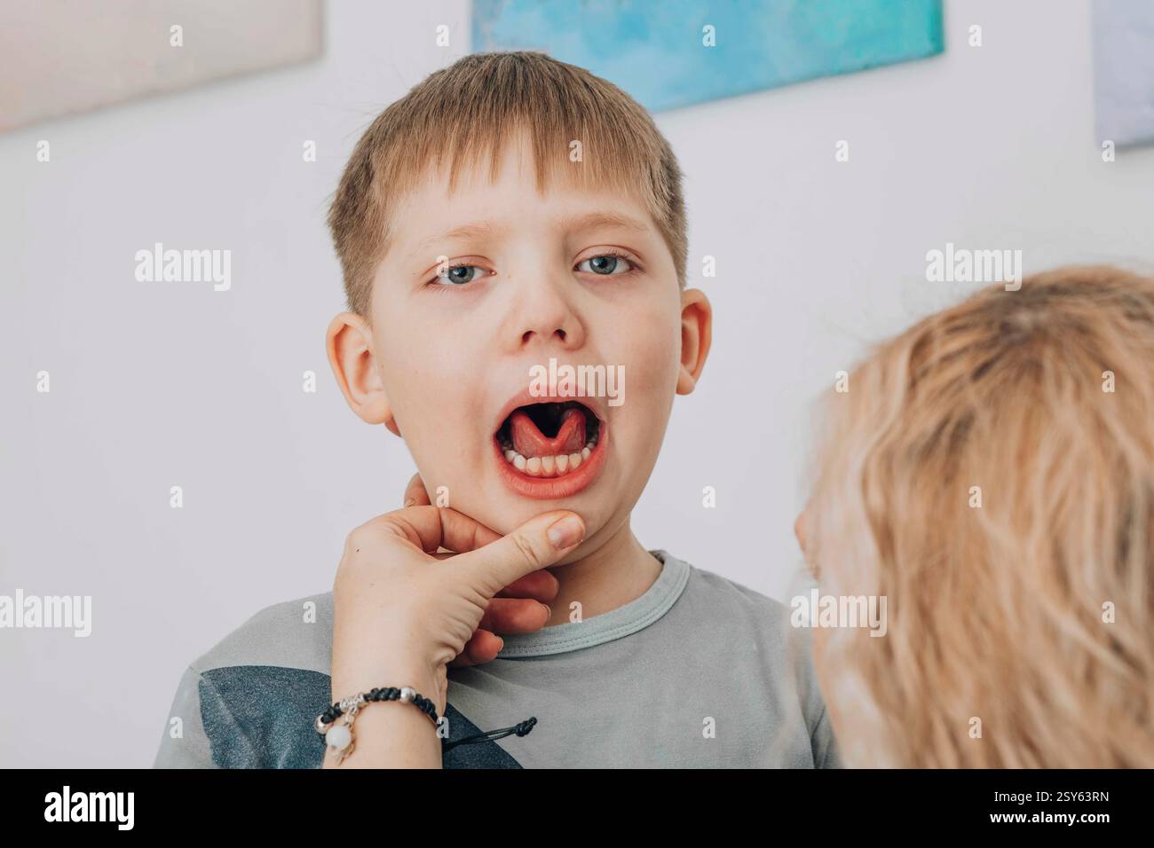 boy, tongue movement during speech therapy session, receiving ...