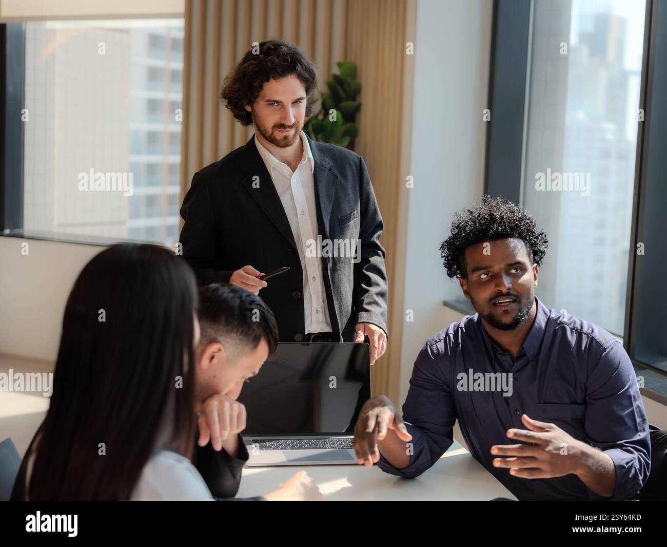 A diverse group of professional business people collaborating and ...