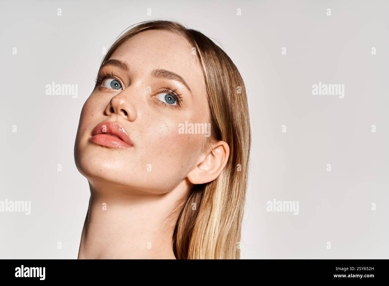 A young woman with blue eyes and smooth skin showcases trendy attire ...