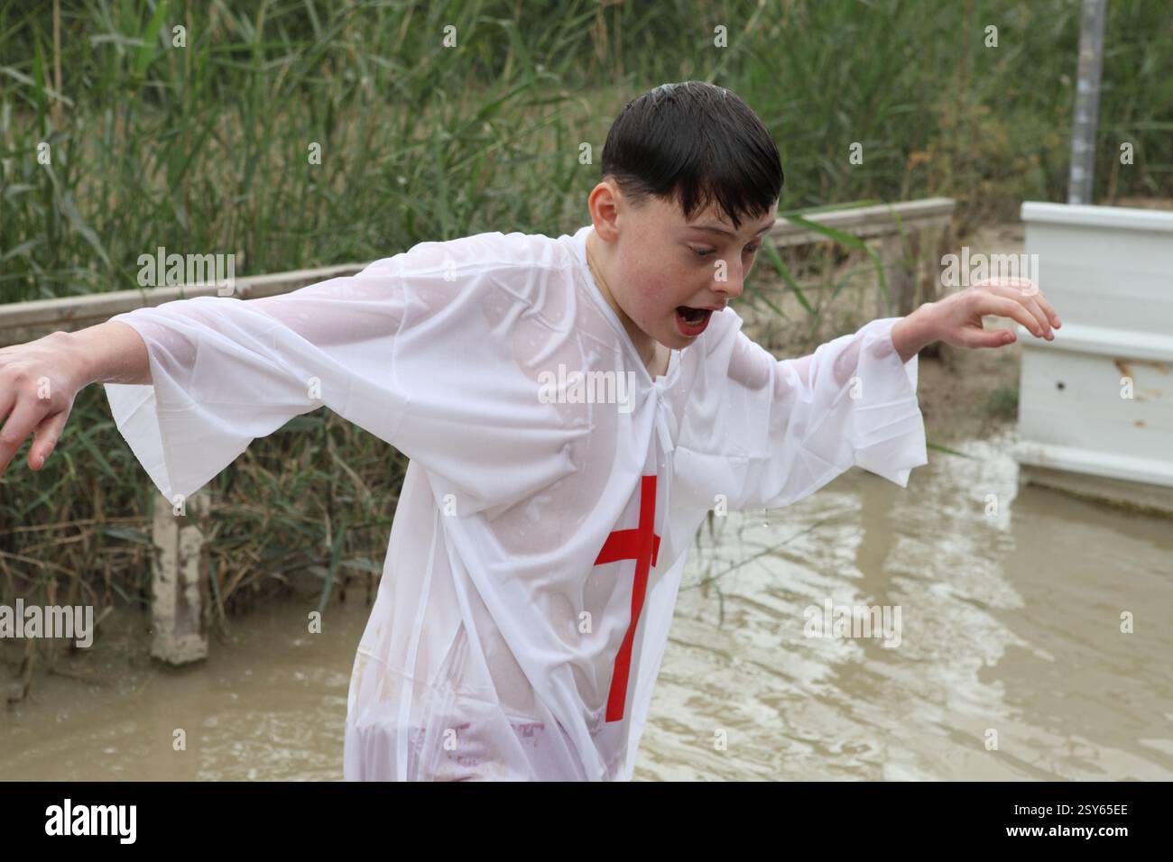Protestant 14 year old English boy coming out of water after baptising ...