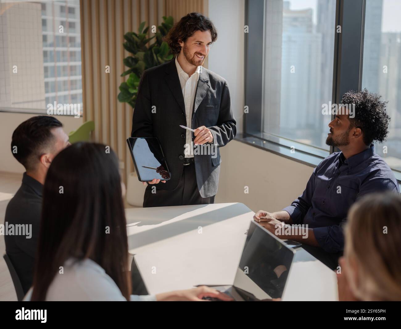 Group of business professionals collaborating and discussing strategy ...