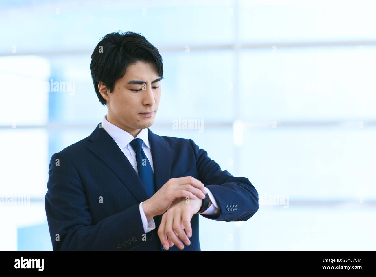 Japanese Businessman Checking Watch Stock Photo - Alamy