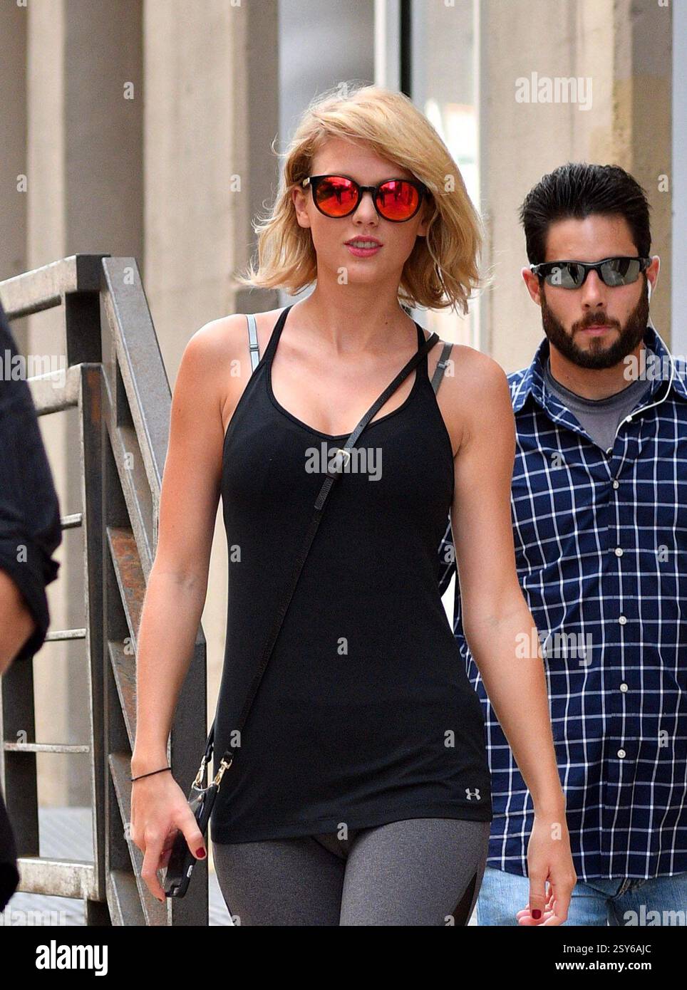 Singer Taylor Swift wears yoga pants and a tank top as she leaves a gym ...